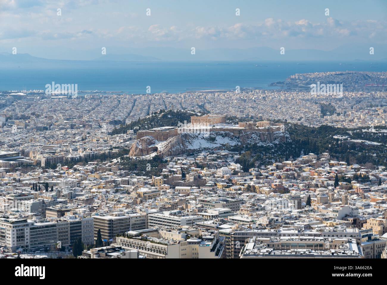 Parthenon temple covered in snow, view from Lycabettus hill after heavy ...