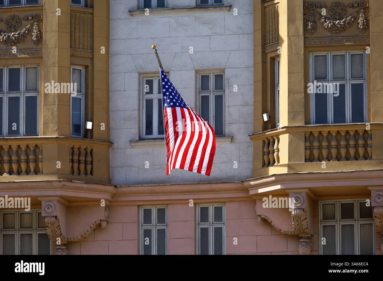 American flag on US embassy facade. Symbol of United State of America ...