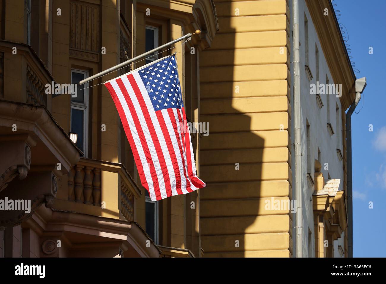 American flag on US embassy facade. Symbol of United State of America ...