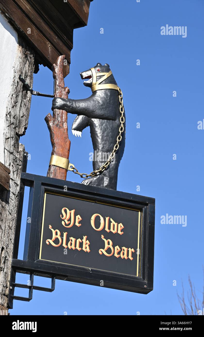 Ye Olde Black Bear pub sign is mounted on the wall of the public house ...