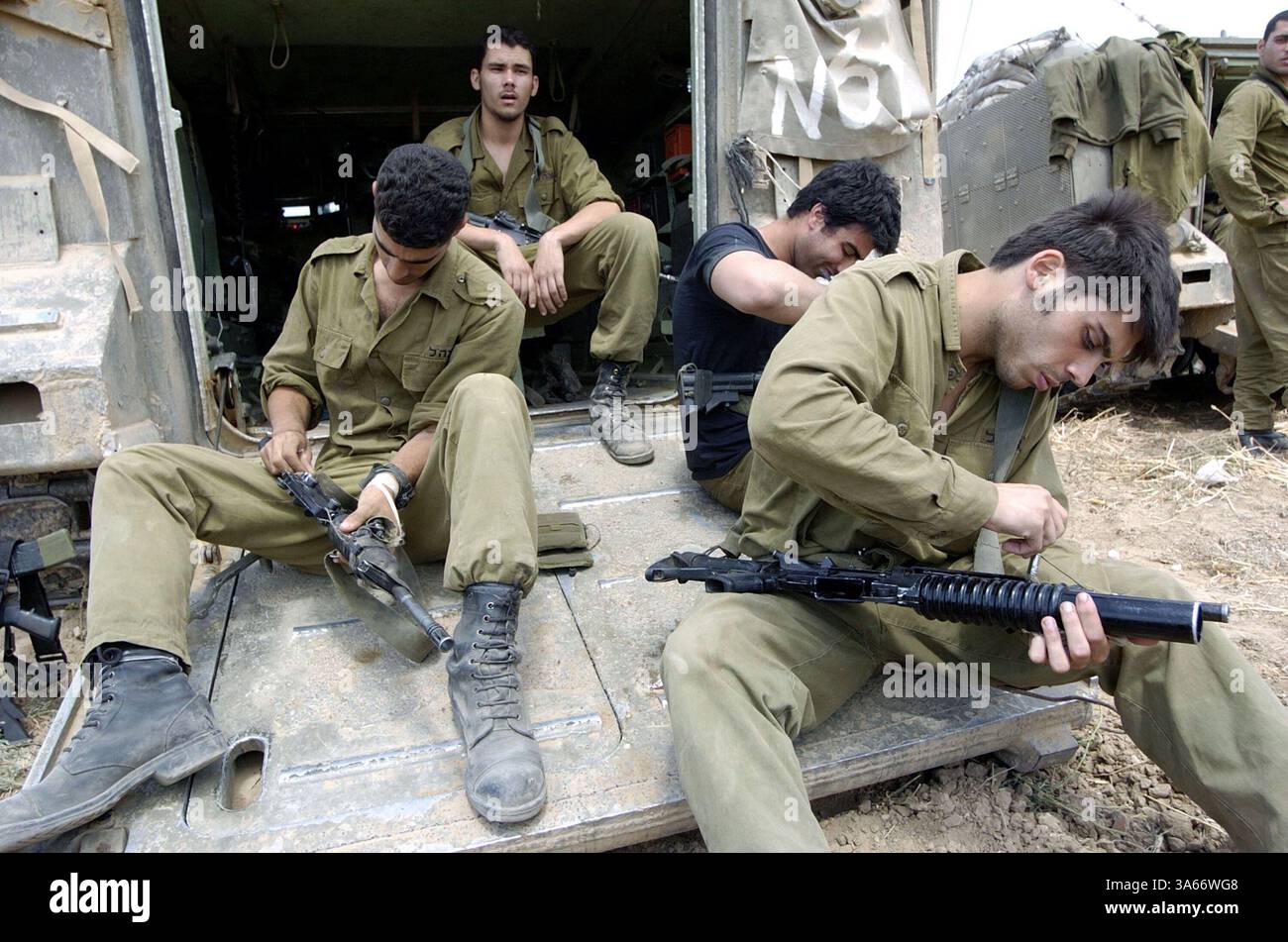 May 12, 2004; Karni Crossing, Israel; Israeli soldiers rest and clean ...