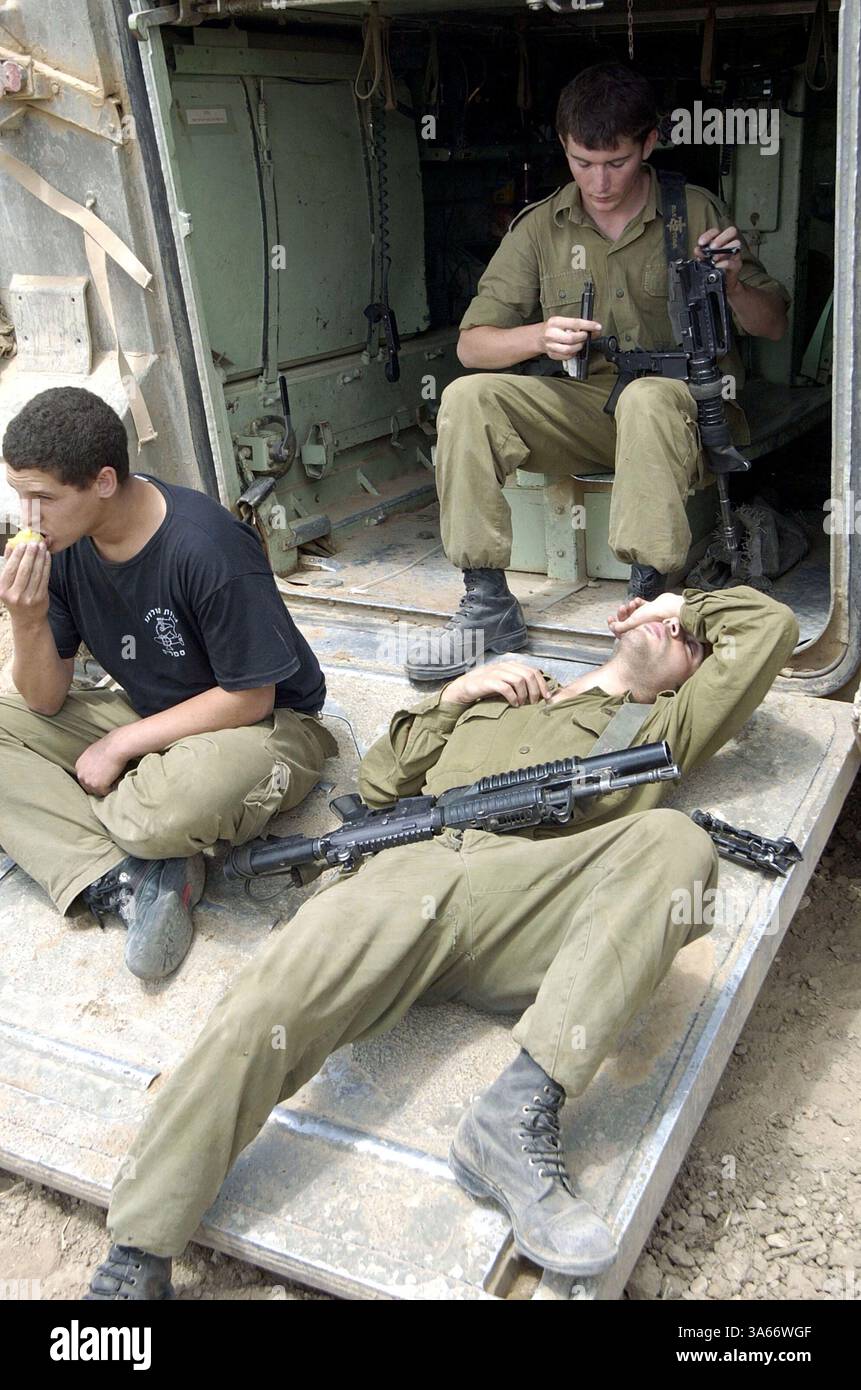 May 12, 2004; Karni Crossing, Israel; Israeli soldiers rest and clean ...