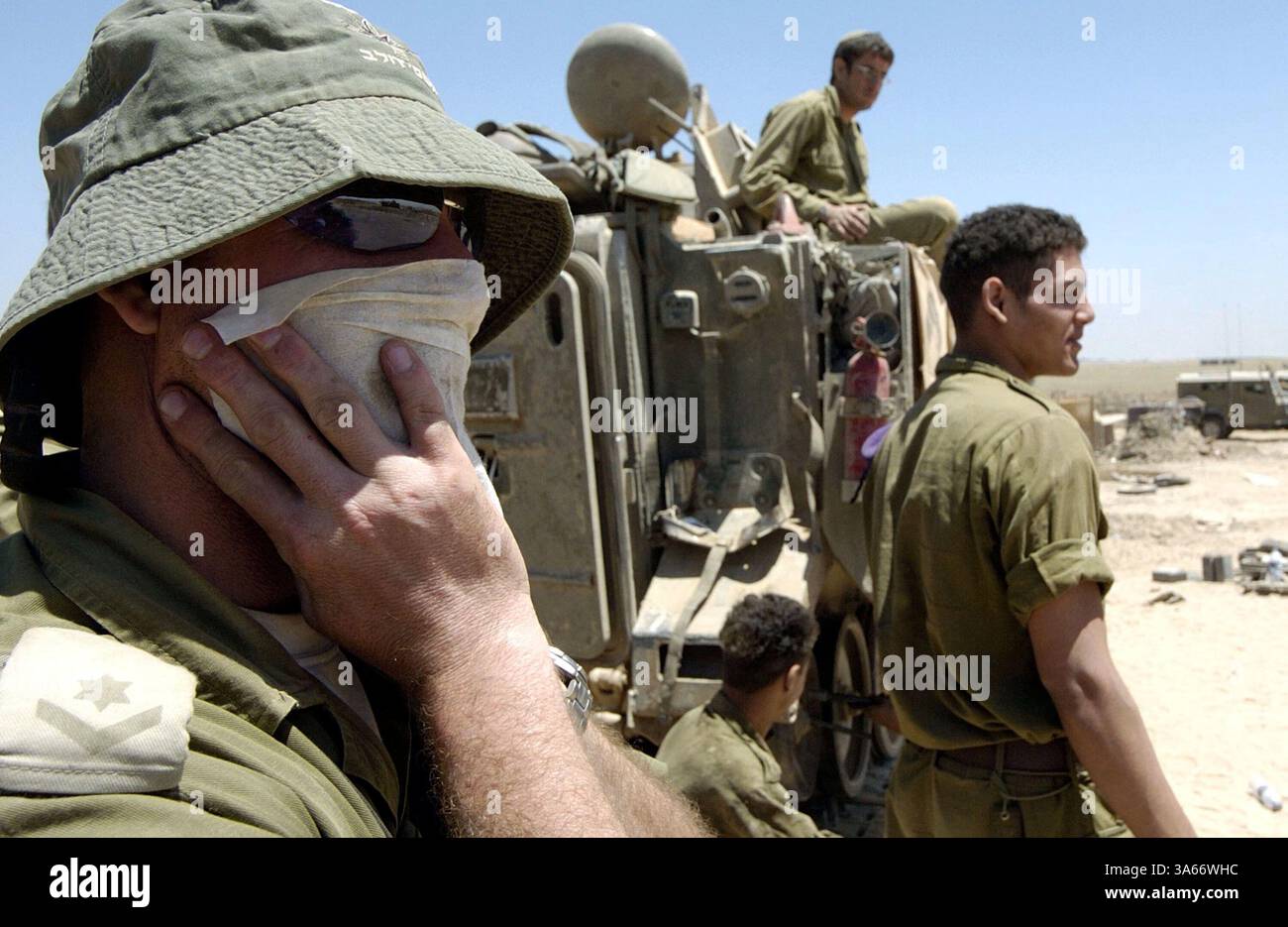 May 12, 2004; Karni Crossing, Israel; Israeli soldiers gather around ...