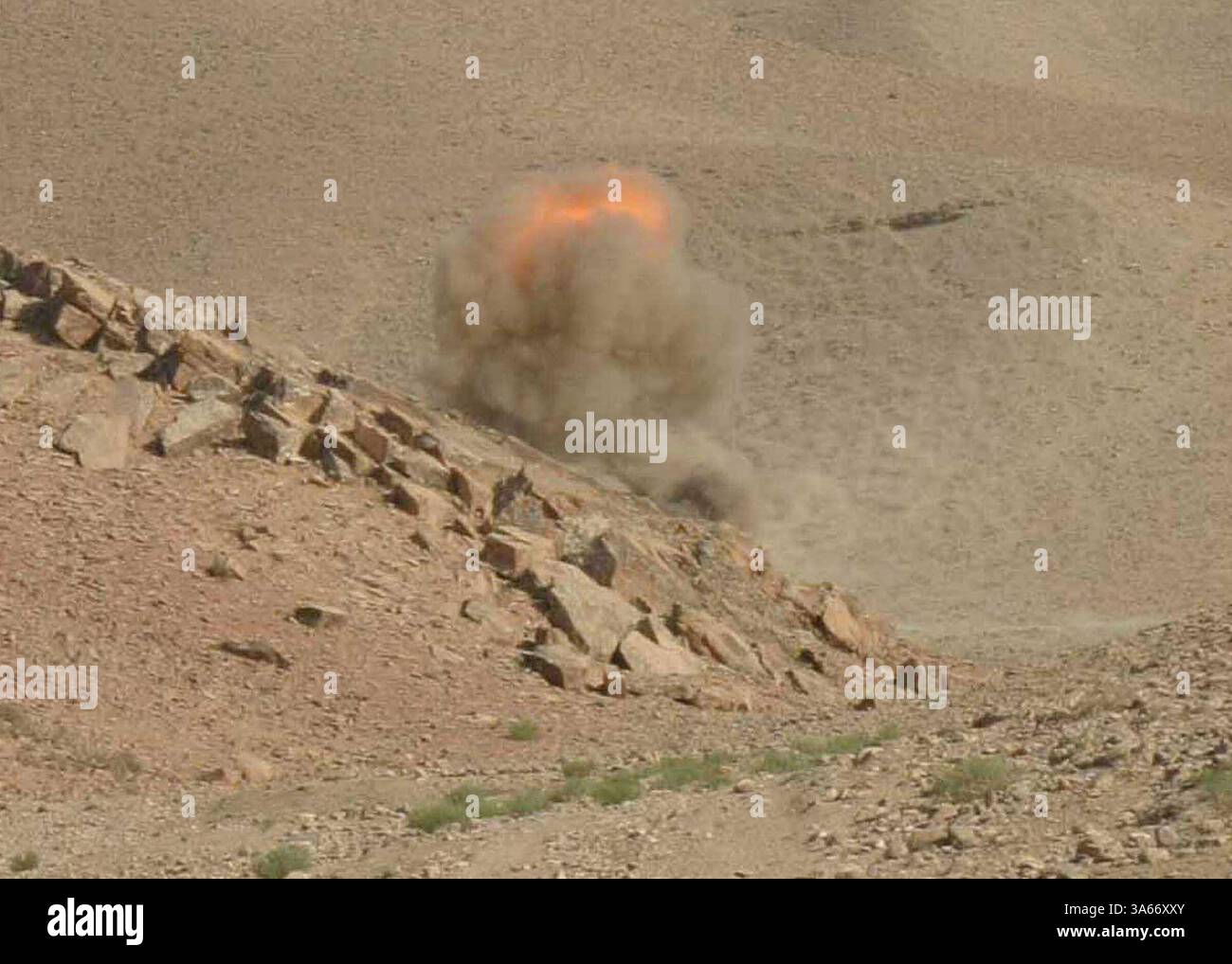 May 25, 2004; Central, Afghanistan; Smoke and fire erupts from a cache ...