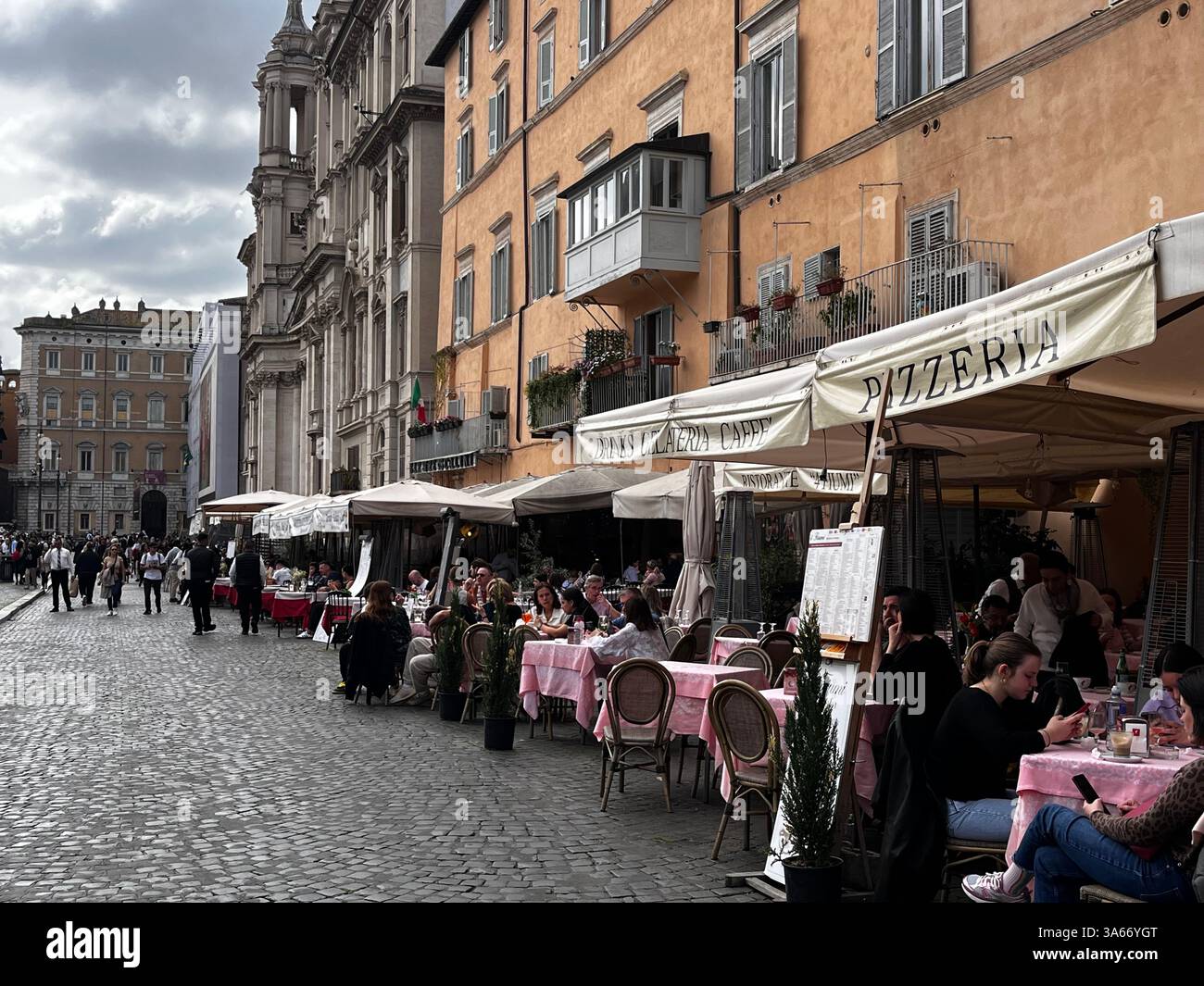 Rome, Italy - March 2025 - Tourists eating at cafe in Piazza Navona ...