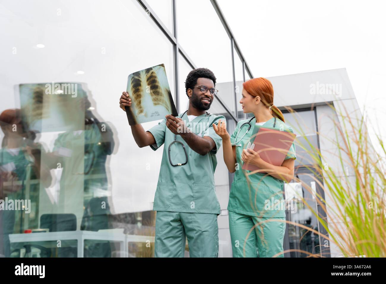 Diverse colleagues looking x ray pictures of bones rib cage or lungs in ...
