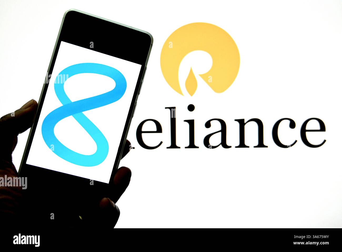 In this photo illustration, a Meta logo is seen displayed on a smartphone with a Reliance logo ...