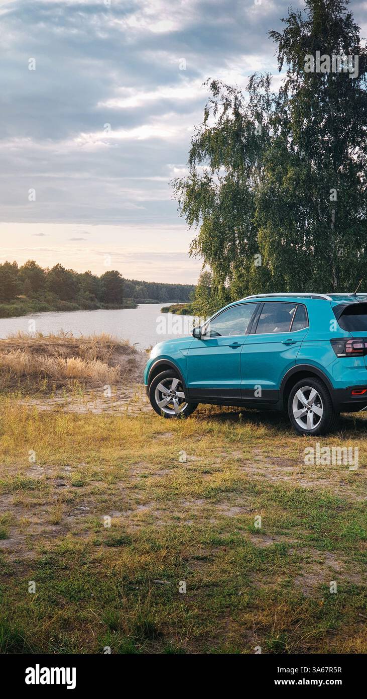 Side view of a turquoise teal-colored urban SUV Volkswagen T-cross on ...