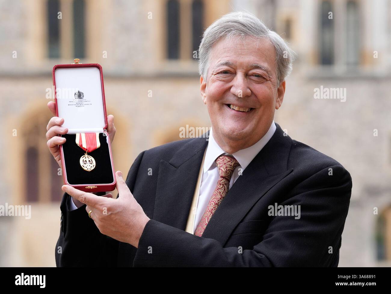 Sir Stephen Fry after being made a Knight Bachelor at an Investiture ceremony at Windsor Castle ...
