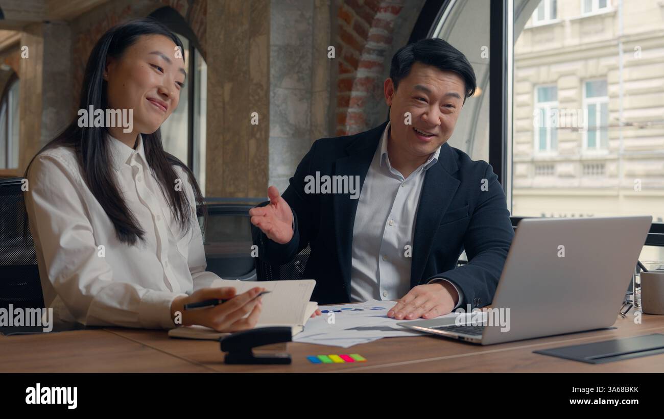 Two Asian business colleagues Korean coworkers Chinese adult middle ...