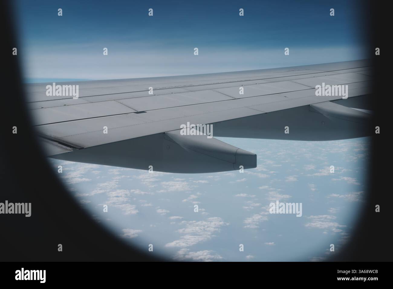 Experience the Captivating InFlight View of the Airplane Wing Gliding Gracefully Above the ...