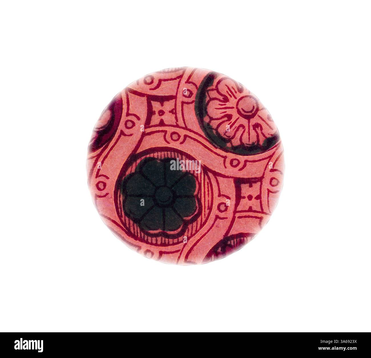 A circular object adorned with intricate floral patterns in contrasting ...