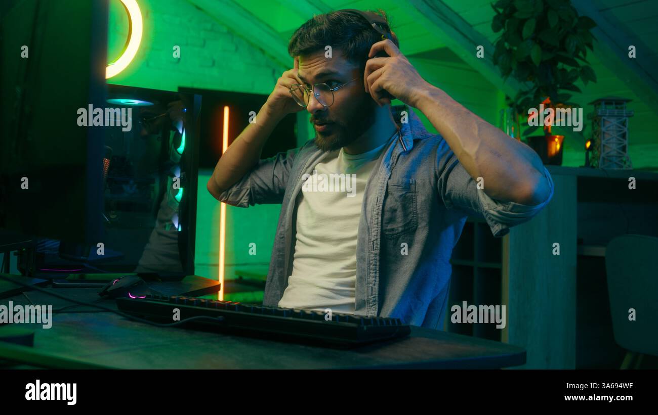 Happy Indian man put on headphone talking to microphone start online ...