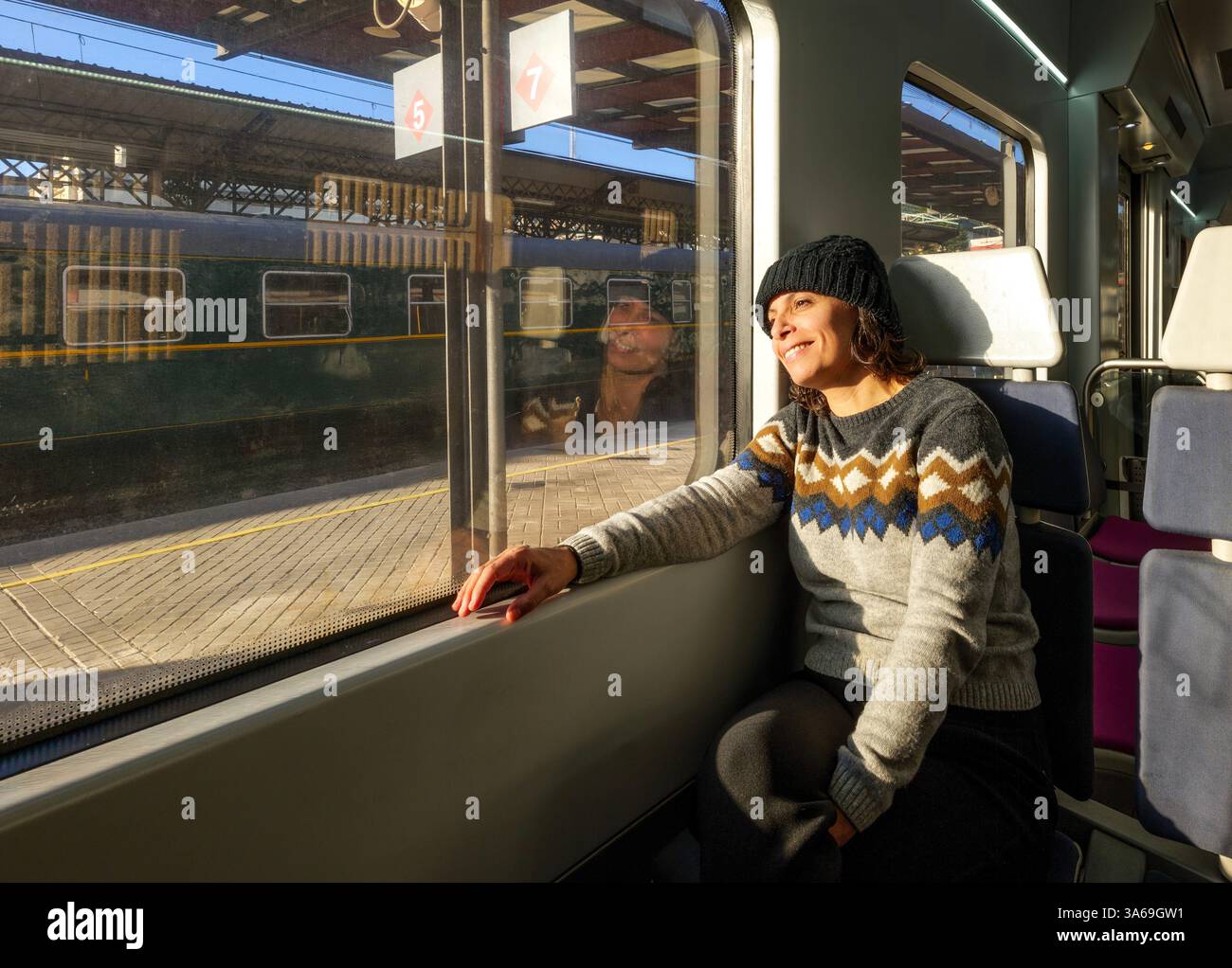 Passenger enjoying a scenic train ride, with a window view of the ...