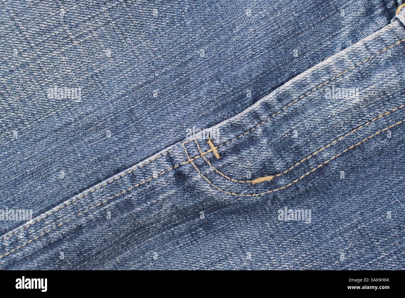 Detail of blue jeans crotch with yellow stitch Stock Photo - Alamy