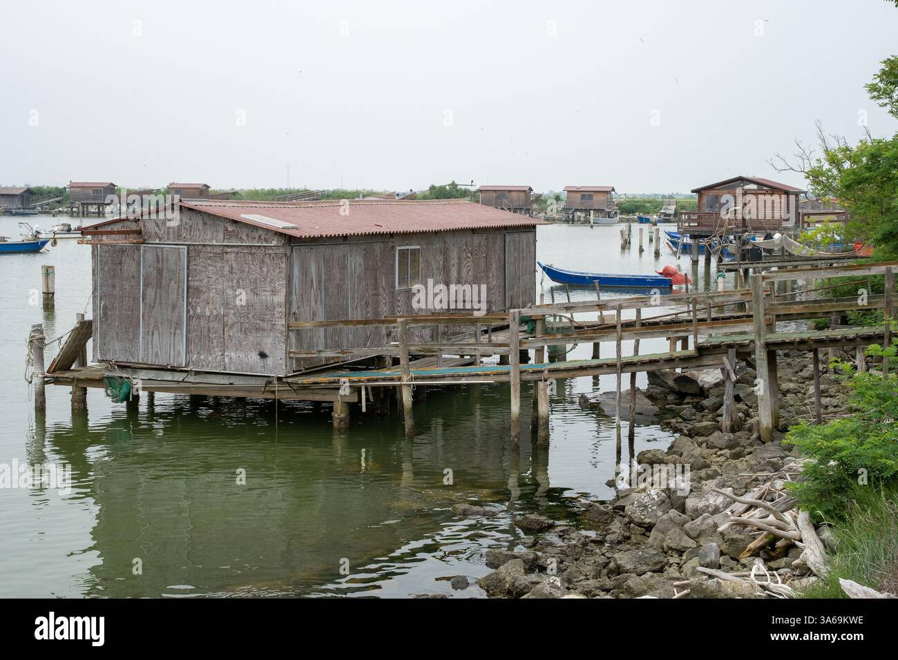 Old wooden fishing hut on stilts in coastal lagoon Stock Photo - Alamy