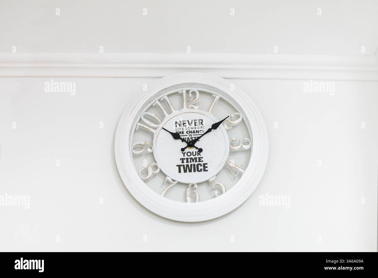 stylish wall clock in a light interior. Changing the clock Stock Photo ...