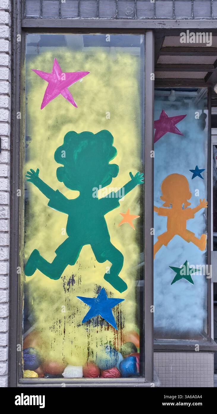Unique mural of kids playing on a shop window. Colorful mural of kids ...