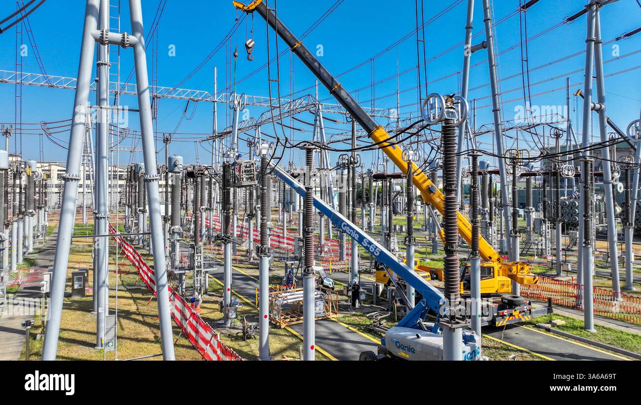 CHANGZHOU, CHINA - MARCH 25, 2025 - Power transmission and transformation company workers ...