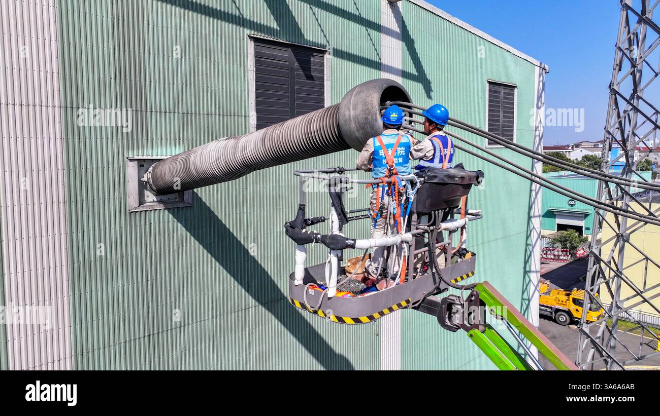 CHANGZHOU, CHINA - MARCH 25, 2025 - Power transmission and transformation company workers ...