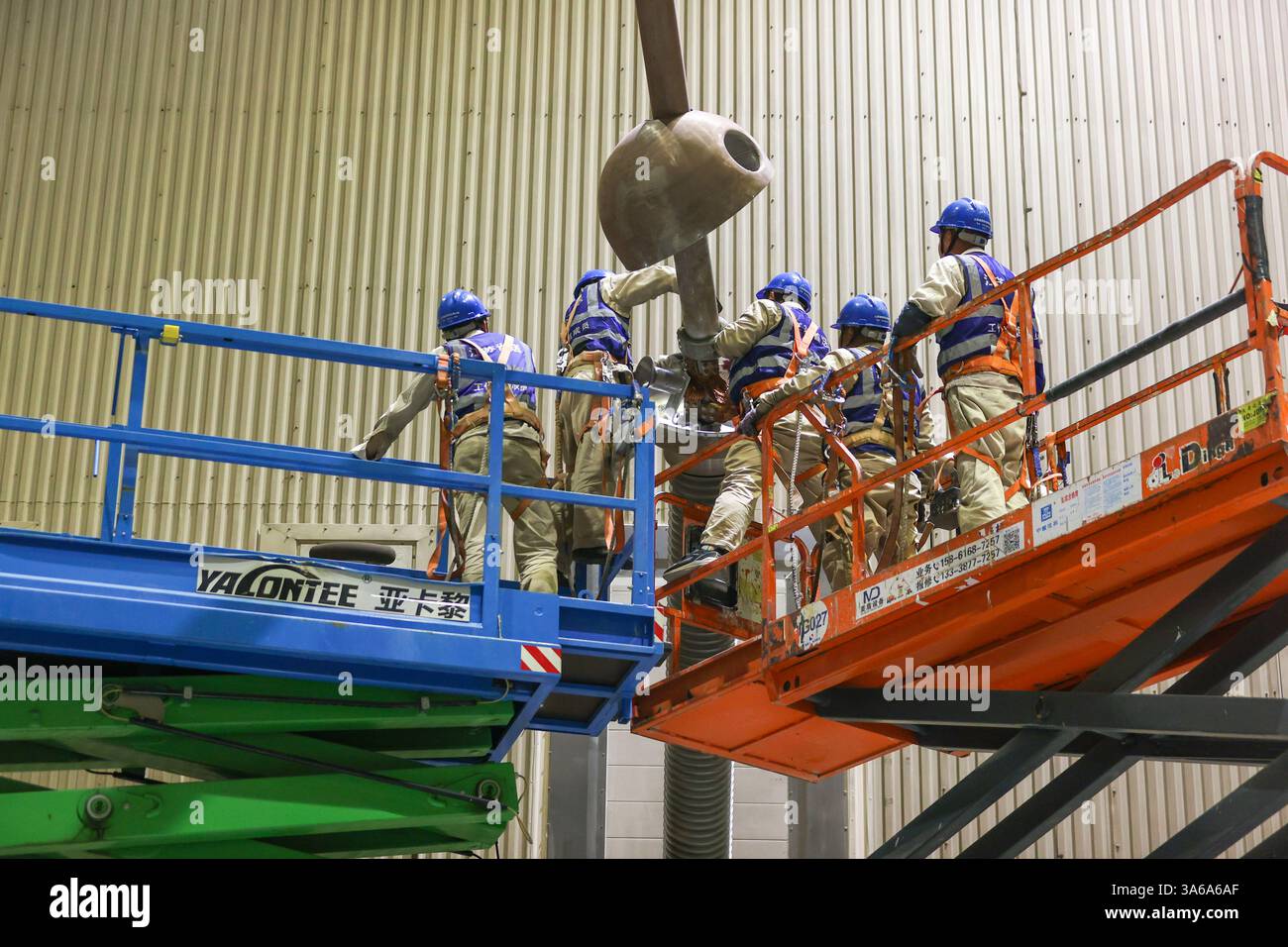 CHANGZHOU, CHINA - MARCH 25, 2025 - Power transmission and transformation company workers ...
