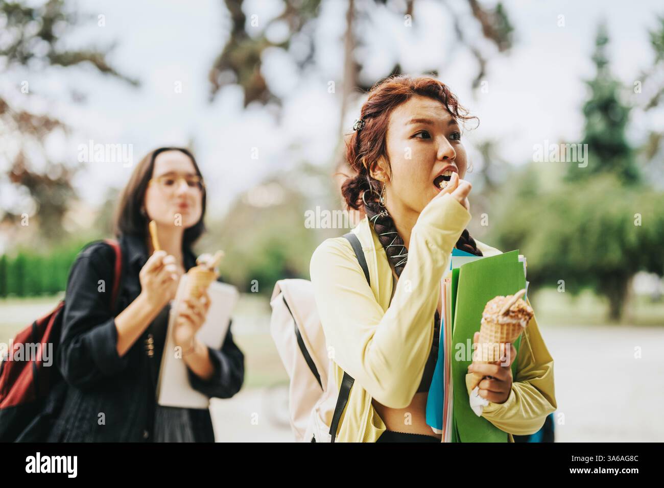 Multicultural students enjoying ice cream break in park setting Stock Photo - Alamy