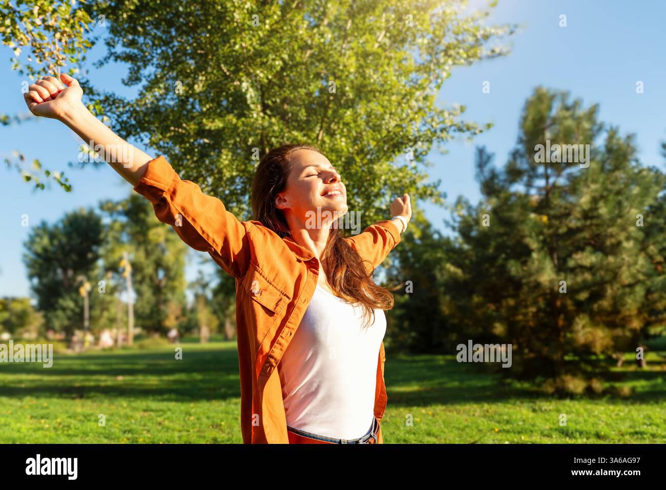 Happy young woman welcomes nature with open arms. Happiness and ...