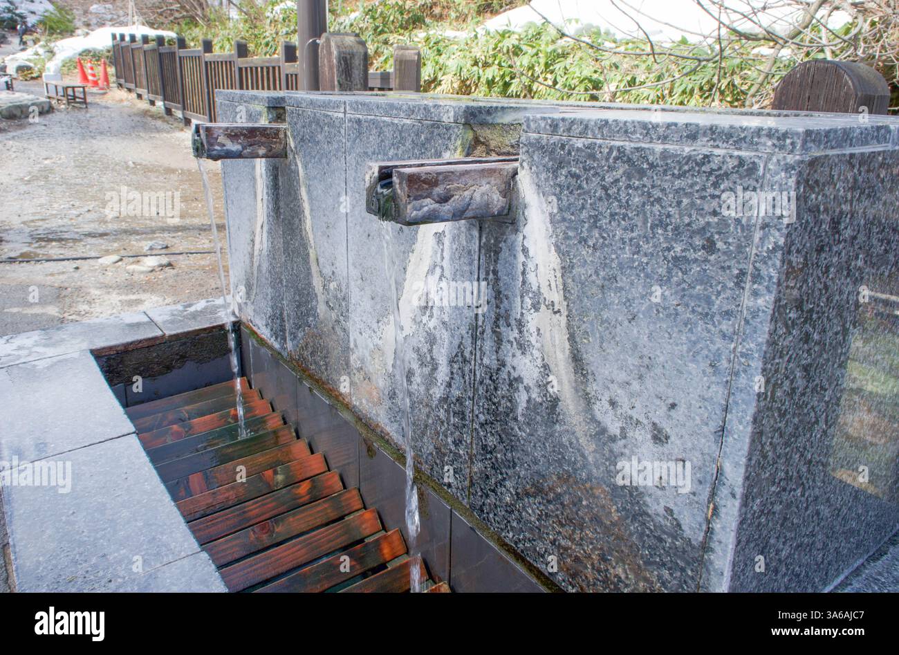 A hot springs stone water fountain at the base of Sainokawara Park, in ...