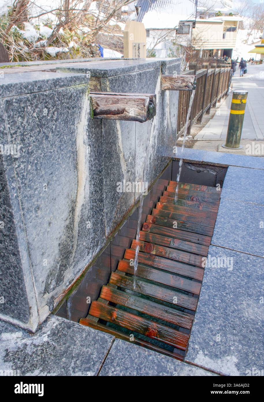 A hot springs stone water fountain at the base of Sainokawara Park, in ...
