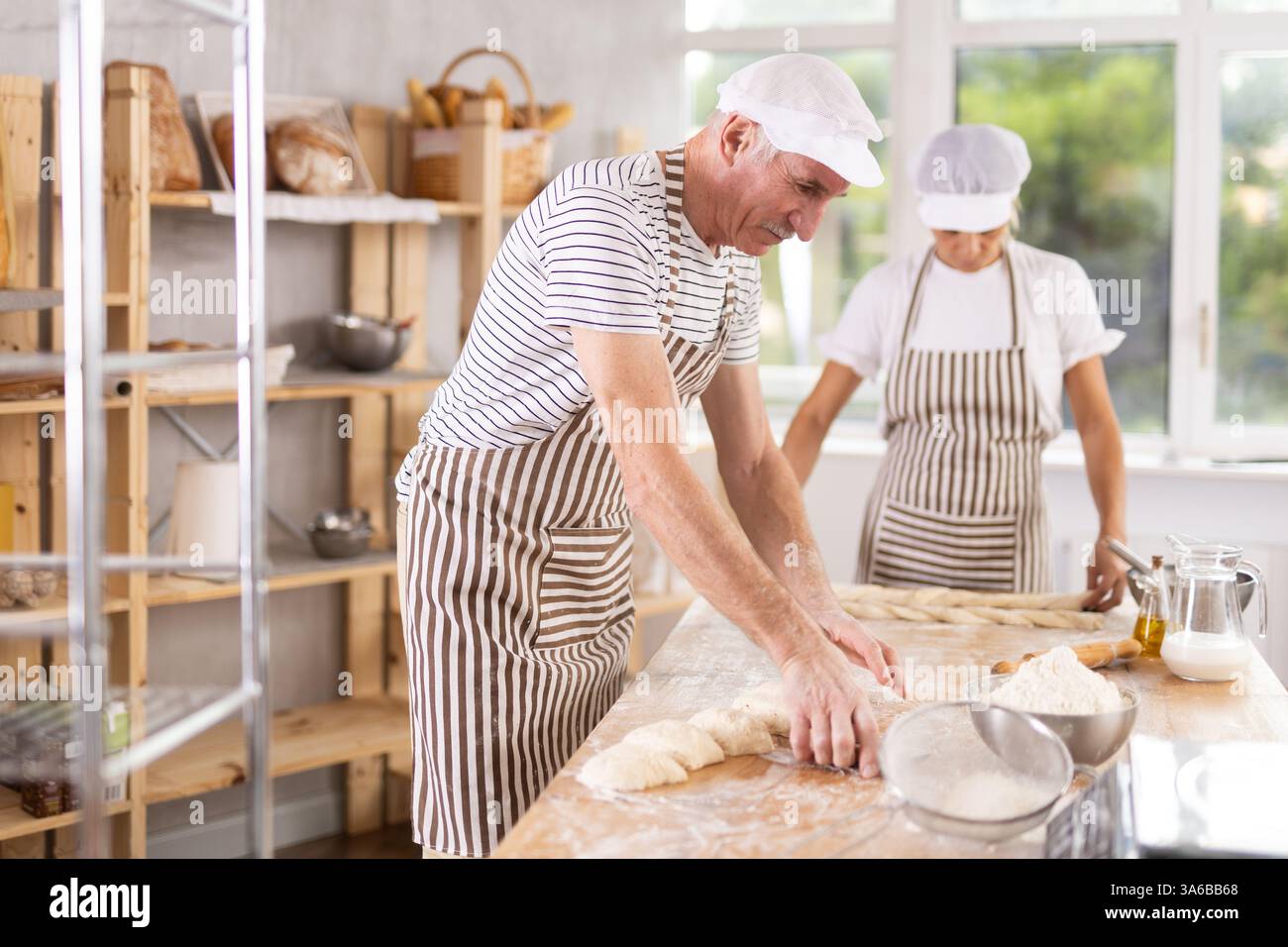 Two bakers work together hi-res stock photography and images - Alamy