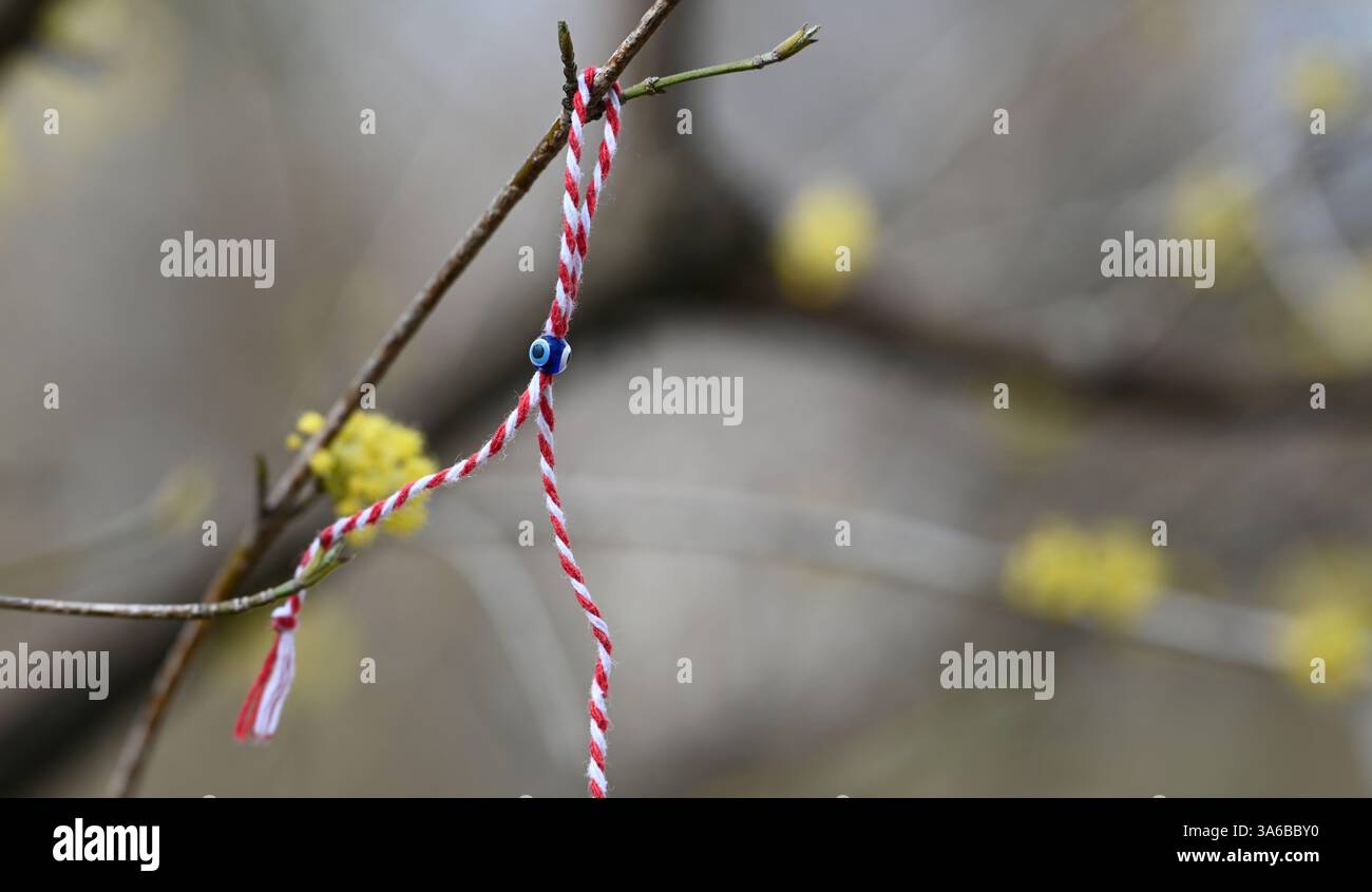 25 March 2025, Bavaria, Munich: A "Martaki" ribbon hangs from a ...