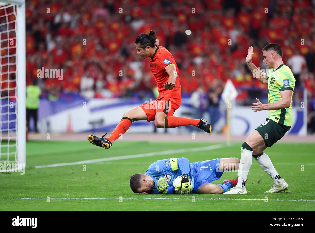 Hangzhou, China. 25th Mar, 2025. Mathew Ryan (down), goalkeeper of ...