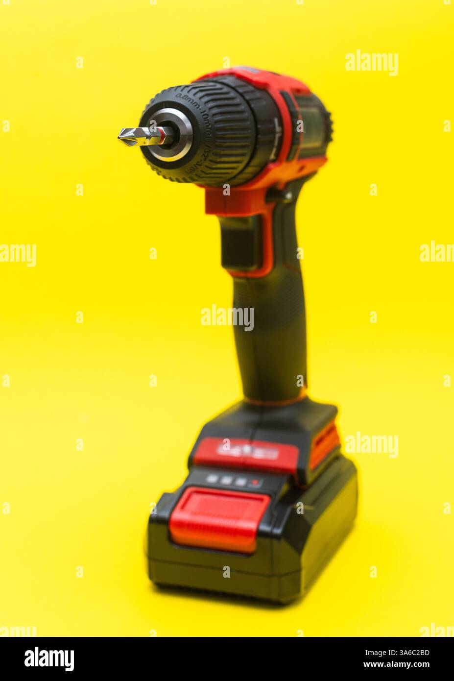modern cordless screwdriver on a yellow background. vertical Stock ...