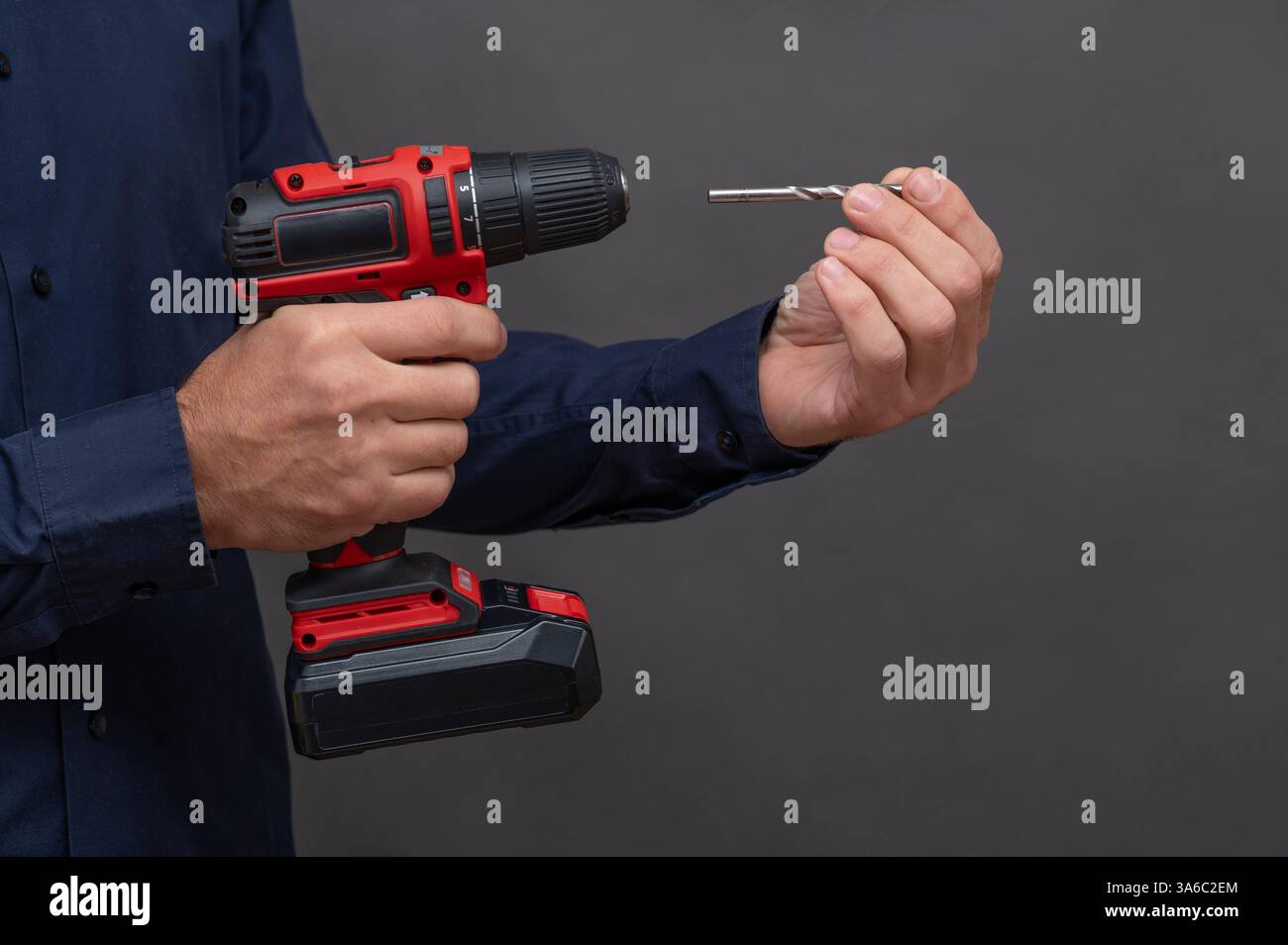 A man installs a drill bit in a cordless screwdriver Stock Photo - Alamy