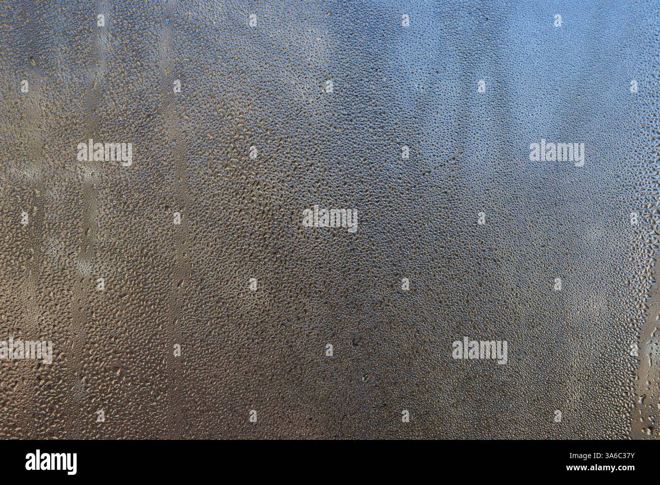 Wet glass window with droplets creating a natural and organic pattern ...