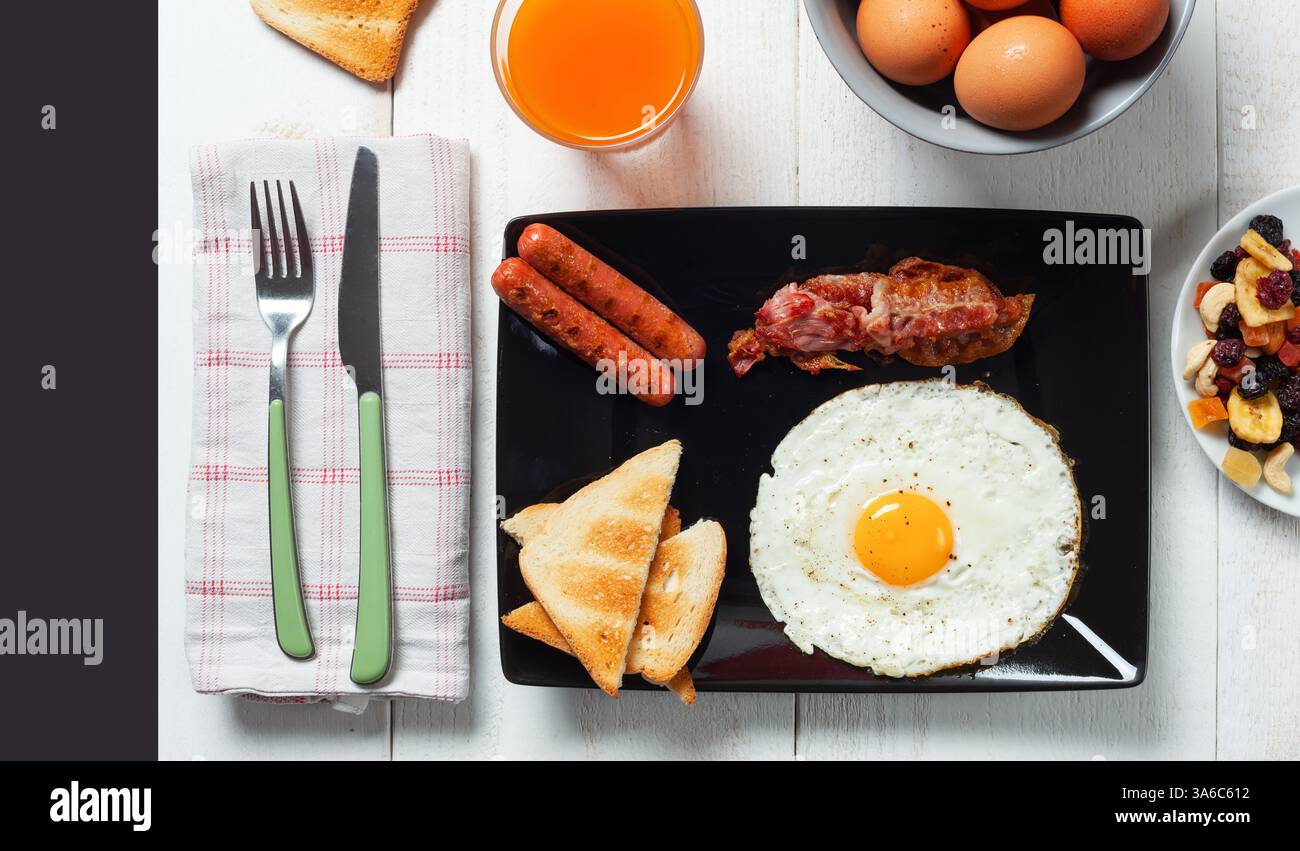 Top view of a full english breakfast consisting of a fried egg, bacon ...