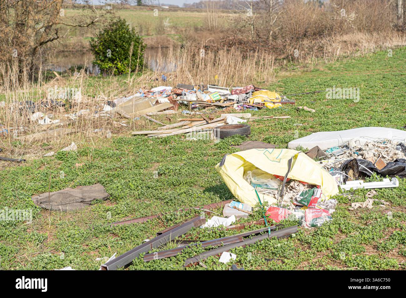 Illegal tipping of rubbish in a farmer's field Stock Photo - Alamy