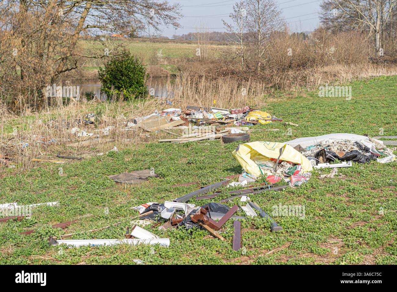 Illegal tipping of rubbish in a farmer's field Stock Photo - Alamy