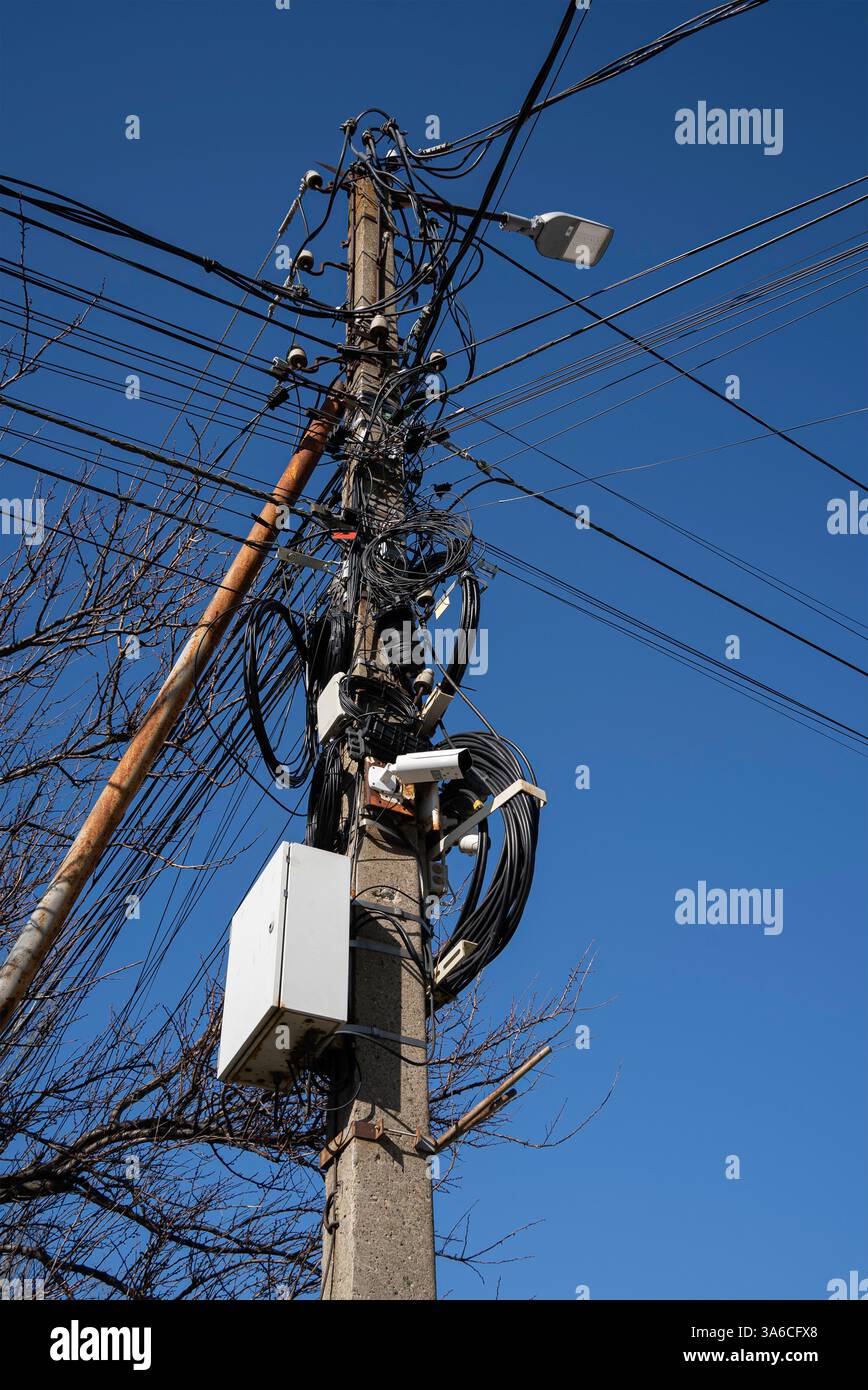 High voltage power pole with wires tangled Stock Photo - Alamy