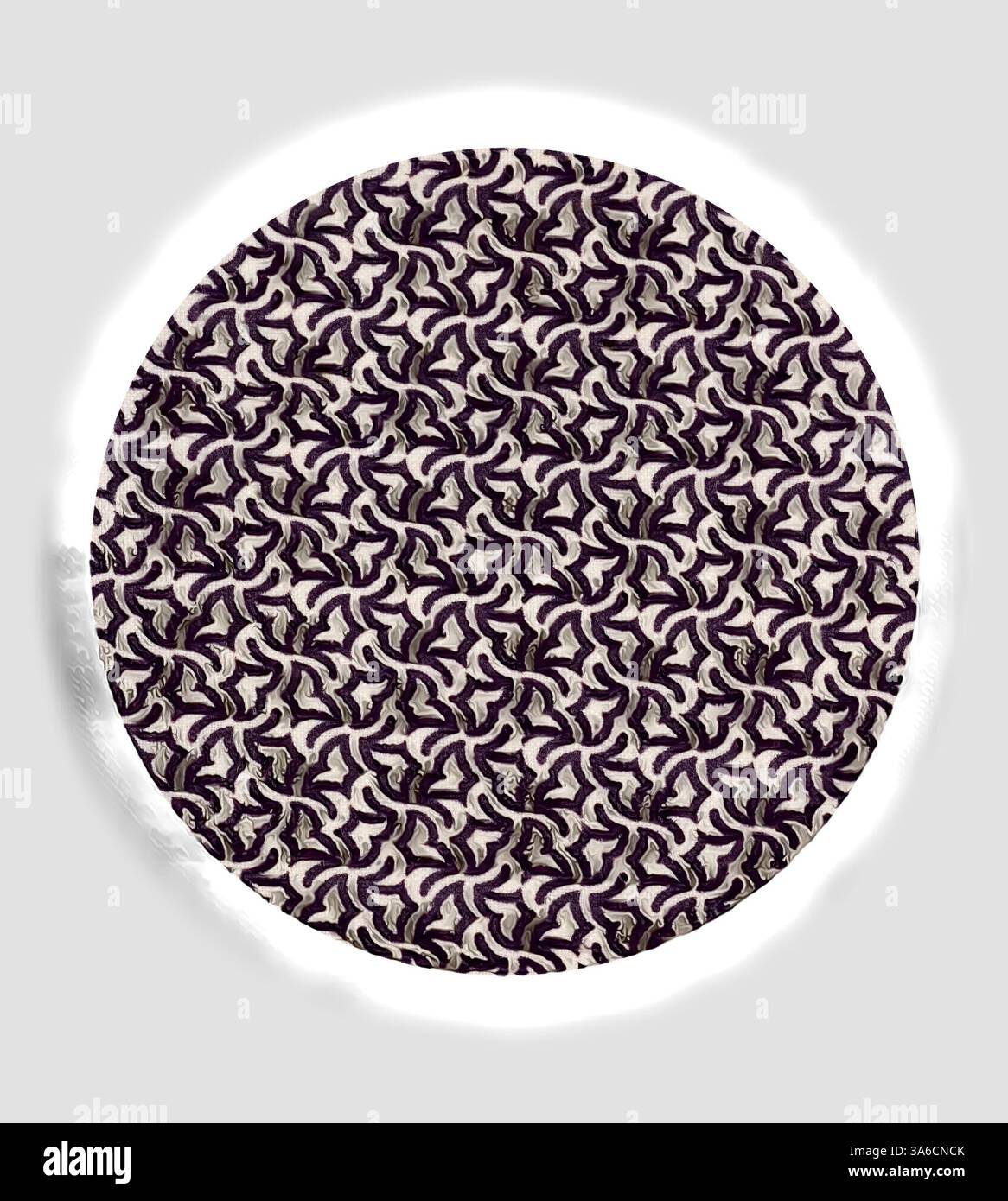 A circular fabric displaying an intricate pattern of swirling shapes in ...