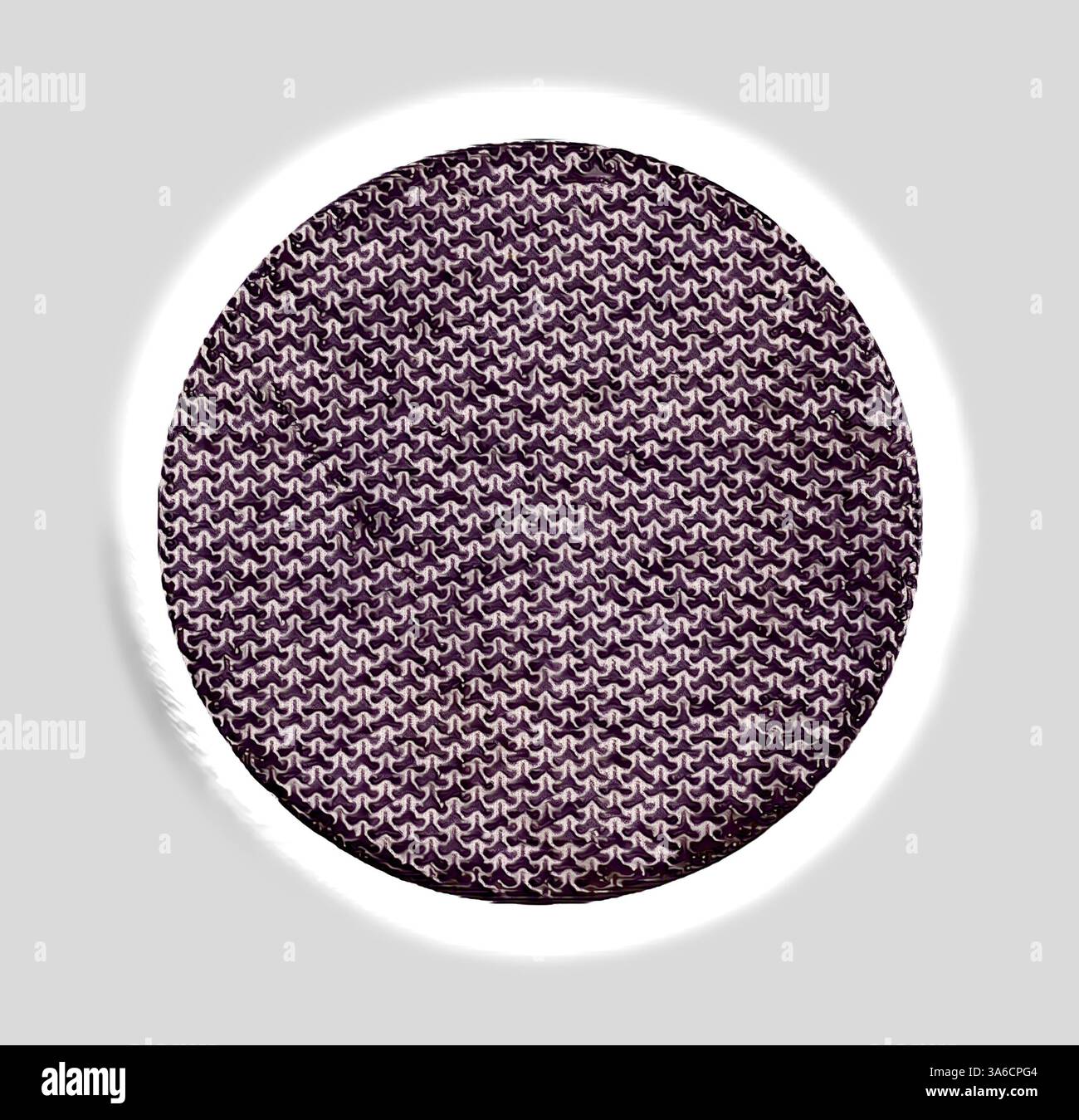 A circular surface featuring a textured pattern of interwoven shapes ...