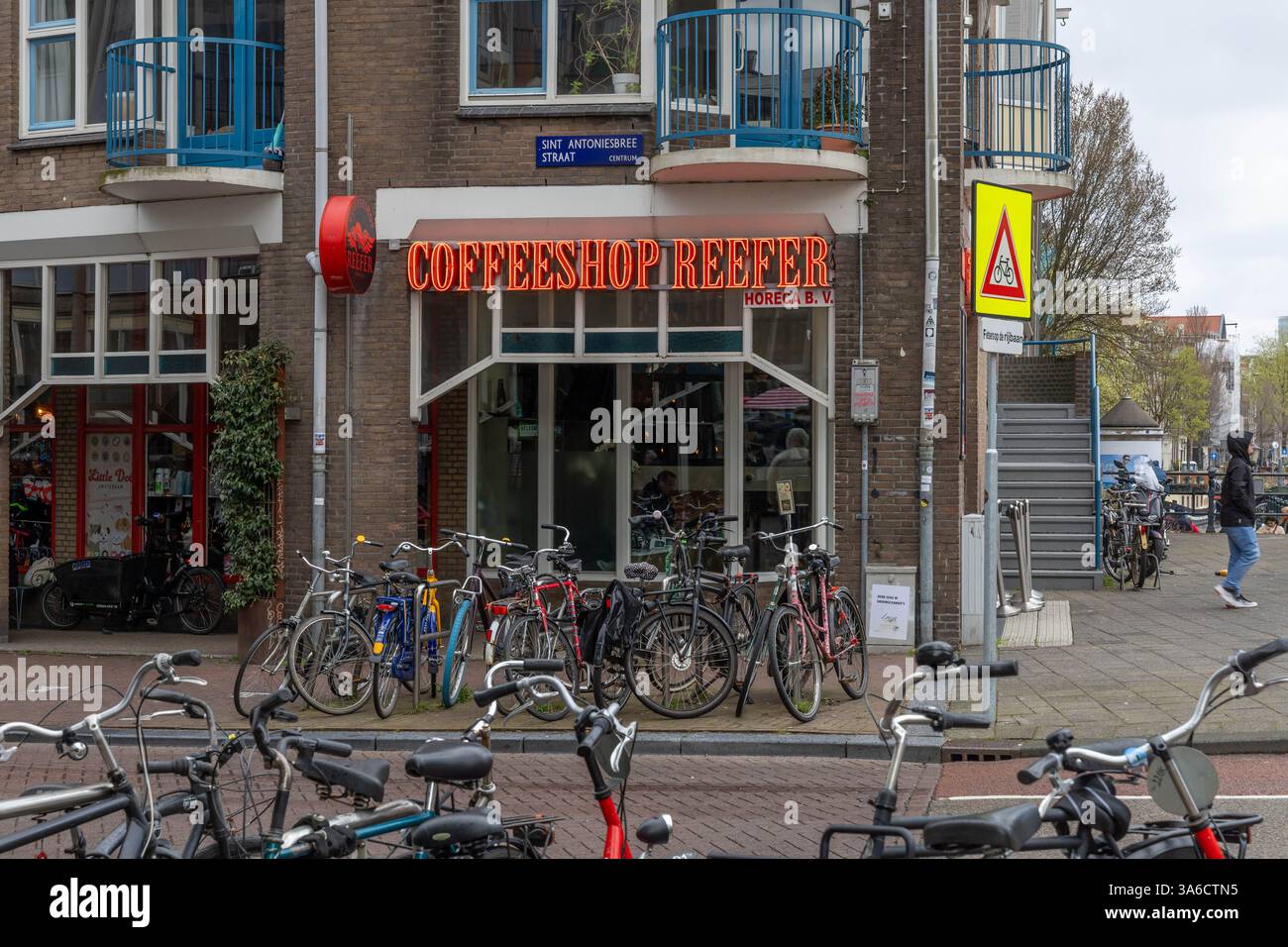 Coffeeshop Reefer front shop with red neon logo sign. bikes in front of ...