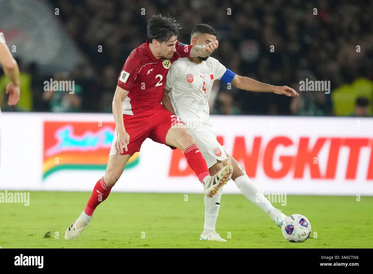 Indonesia's Kevin Diks, left, battles for the ball against Bahrain's ...