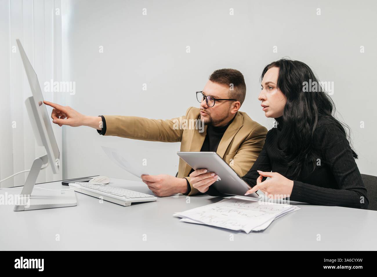 Office employees brainstorm, analyzing charts in a modern, bright ...