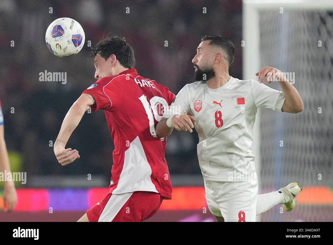 Bahrain's Mohamed Marhoon, right, battles for the ball against ...