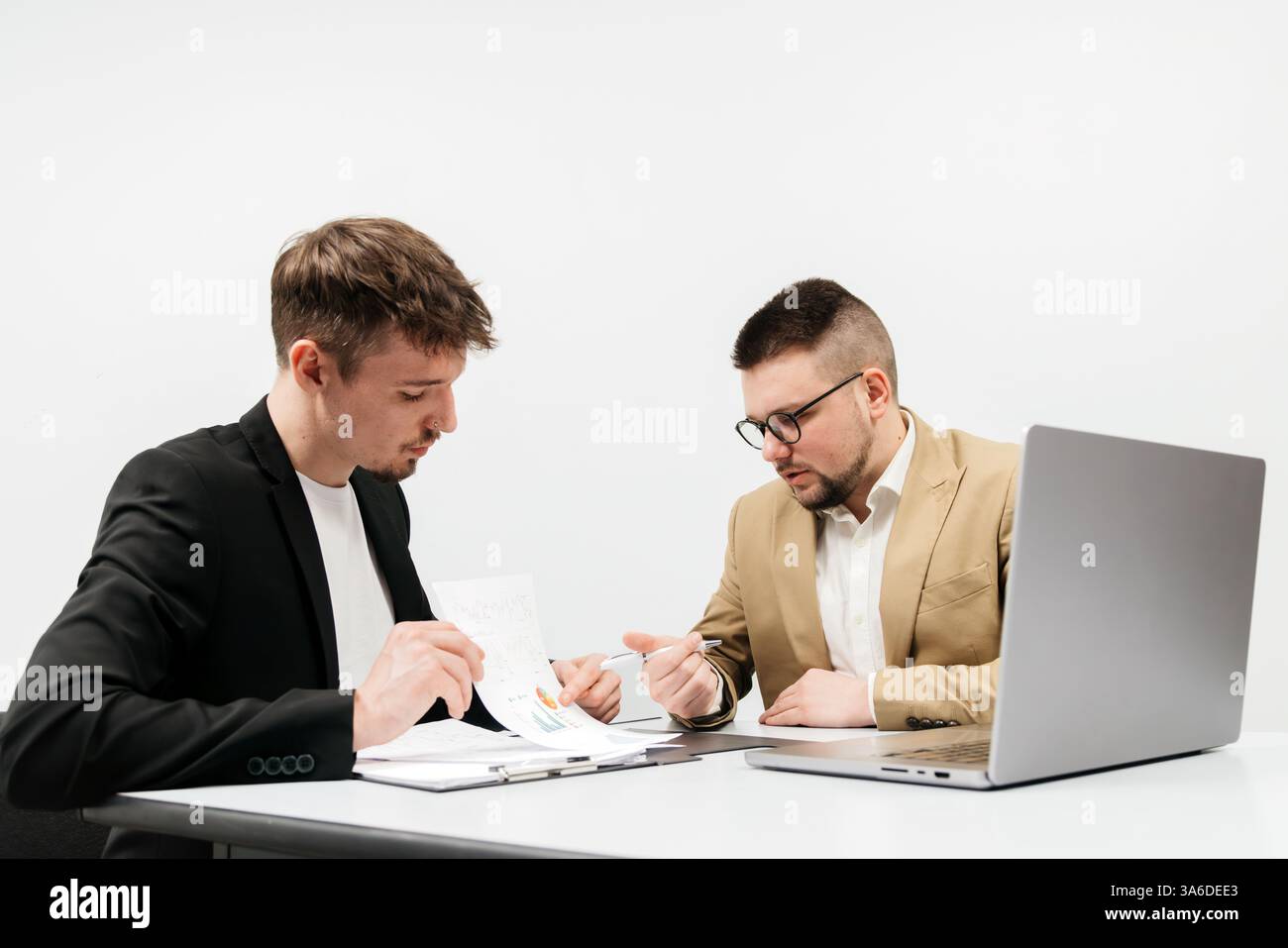 Office employees brainstorm, analyzing charts in a modern, bright ...