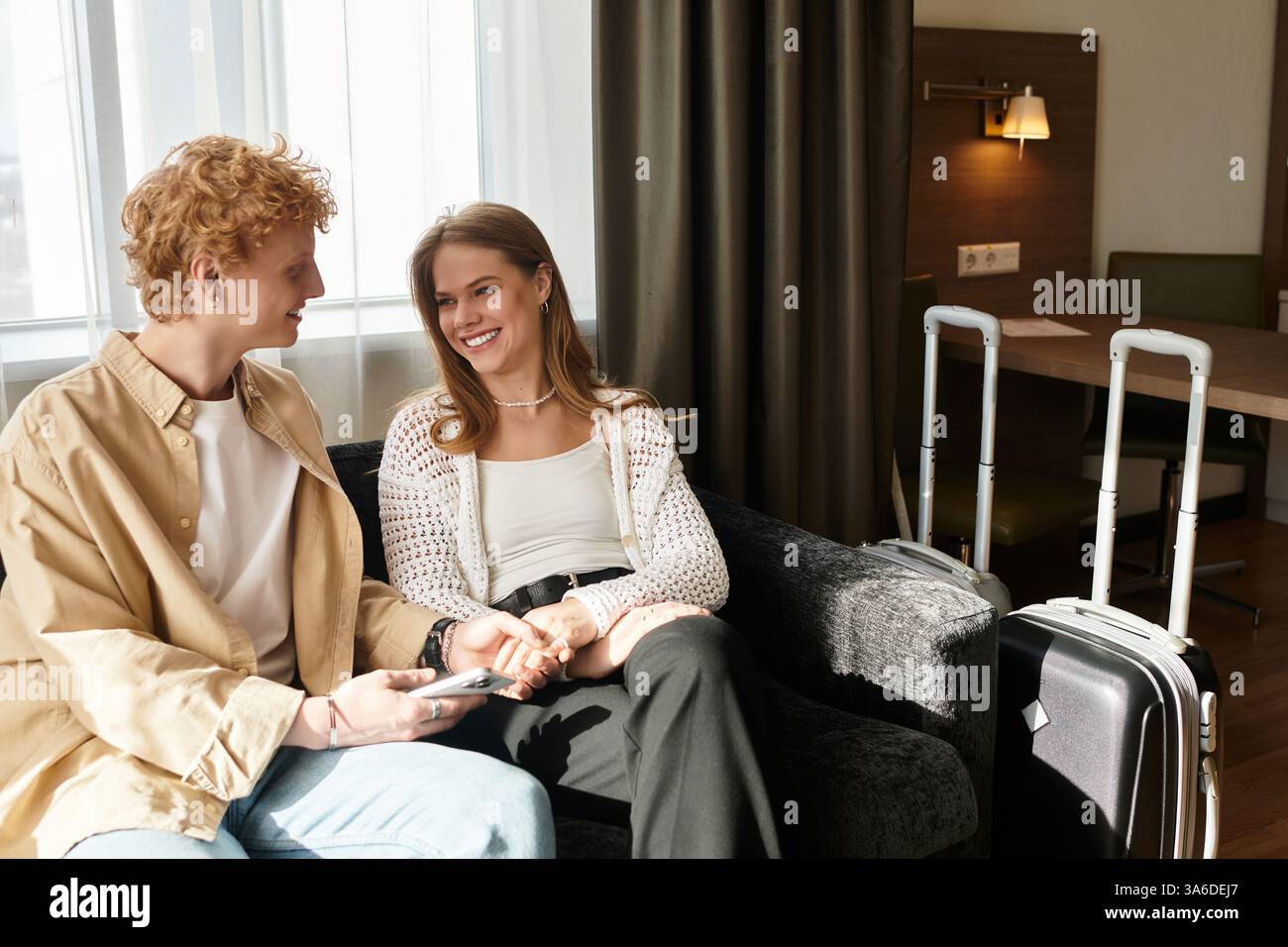 Happy couple shares intimate moments in a stylish hotel room ...