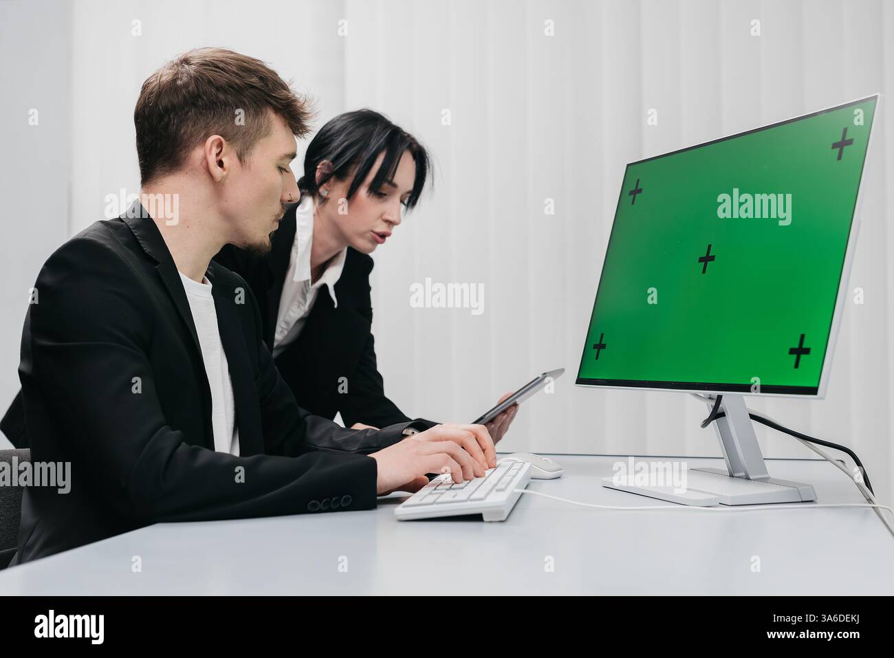 A group of successful businessmen in the office with a desktop computer ...