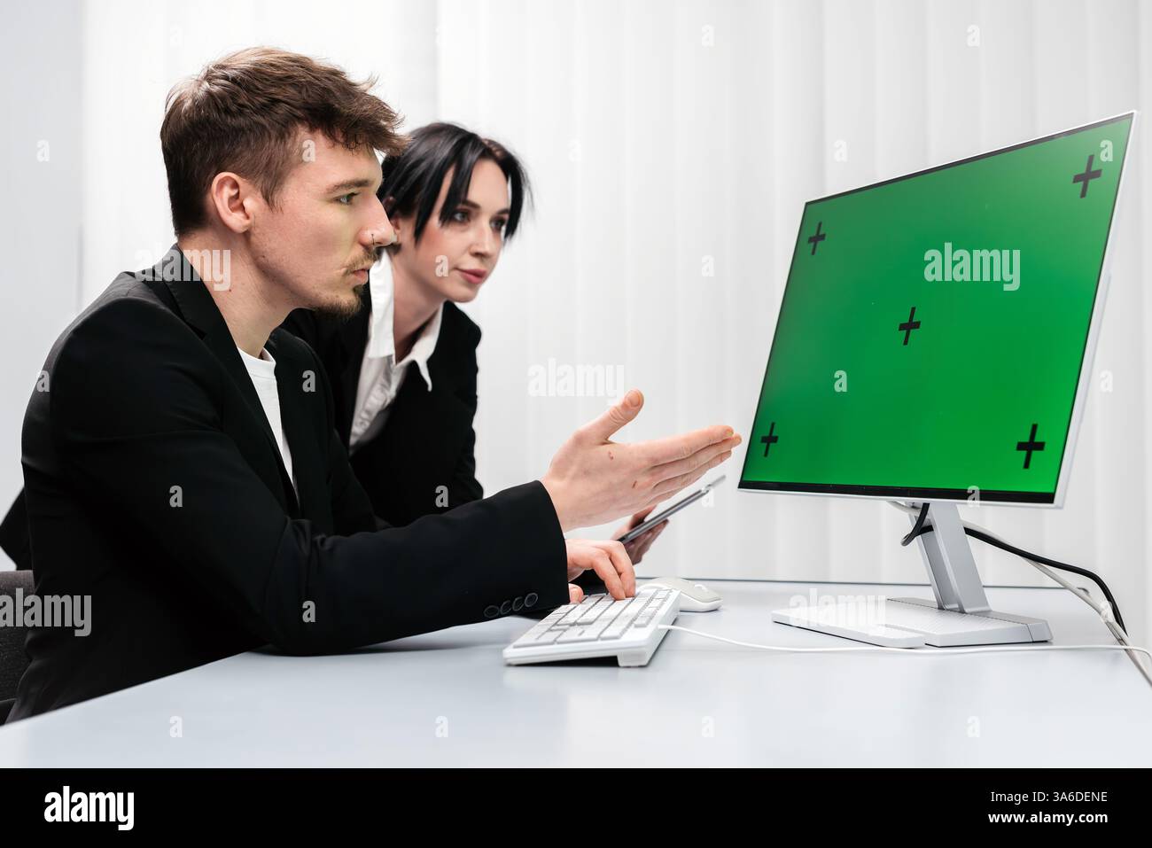 A group of successful businessmen in the office with a desktop computer ...