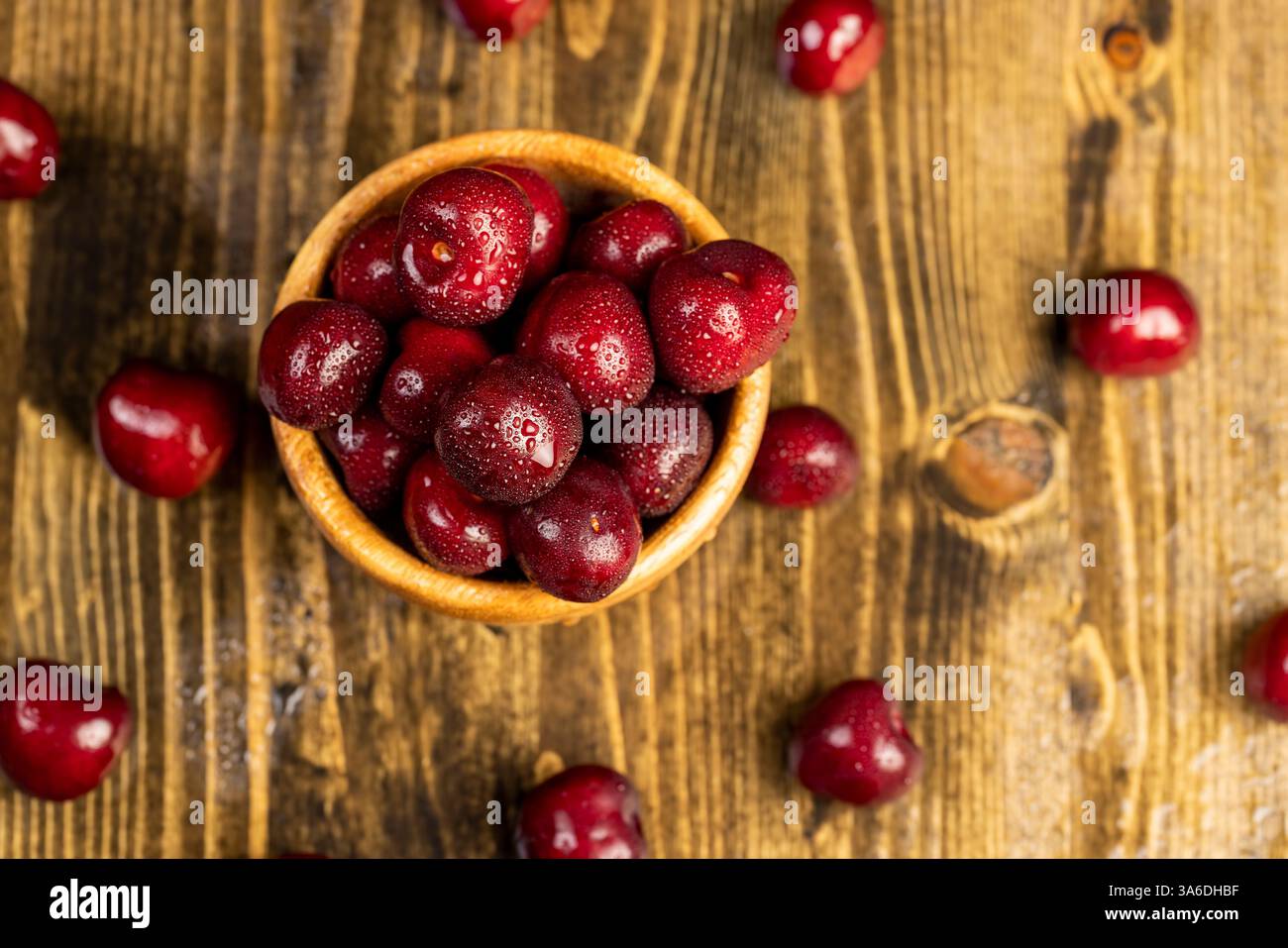 cherry berries in drops of water, wet red cherry fruits on the kitchen ...